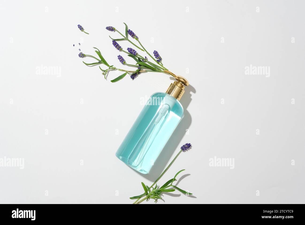 Top view of a transparent perfume bottle containing blue liquid on a ...