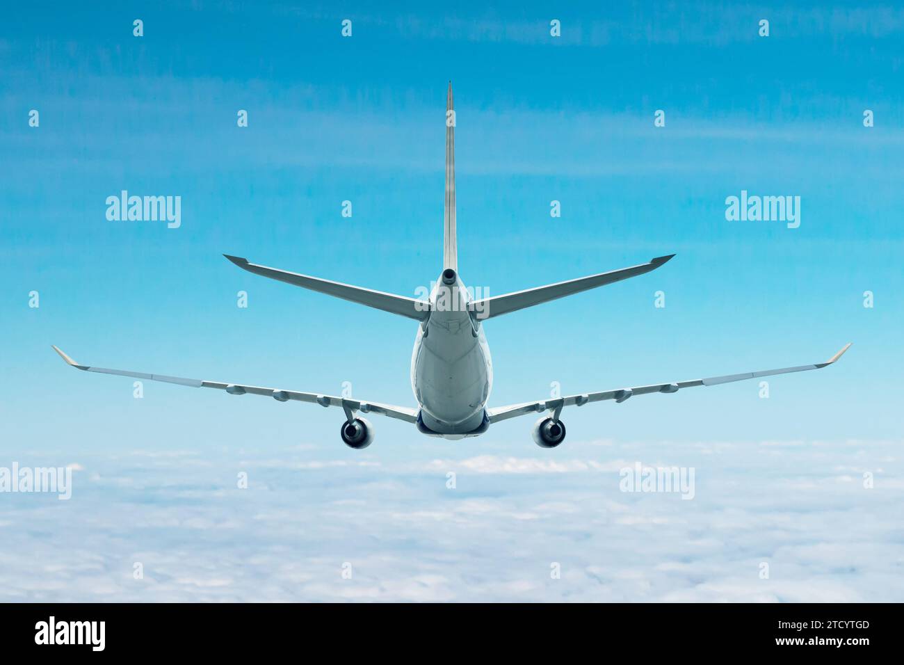 Rear view of a wide body passenger airplane flying in the air above the ...