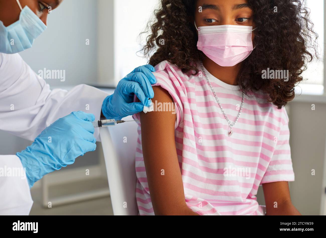 African american doctor giving a vaccine injection vaccination to teen ...
