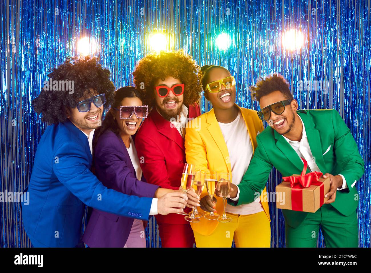 Portrait of multinational funny group of young people at party clinking ...