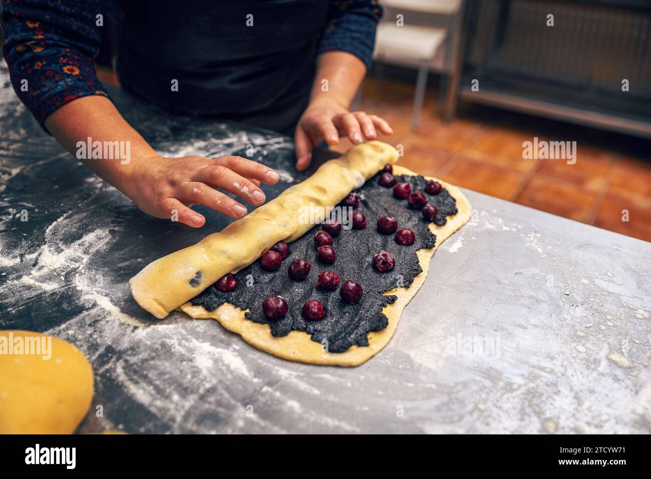 Rolling filling dough for make babka. Bakery procedure Stock Photo - Alamy