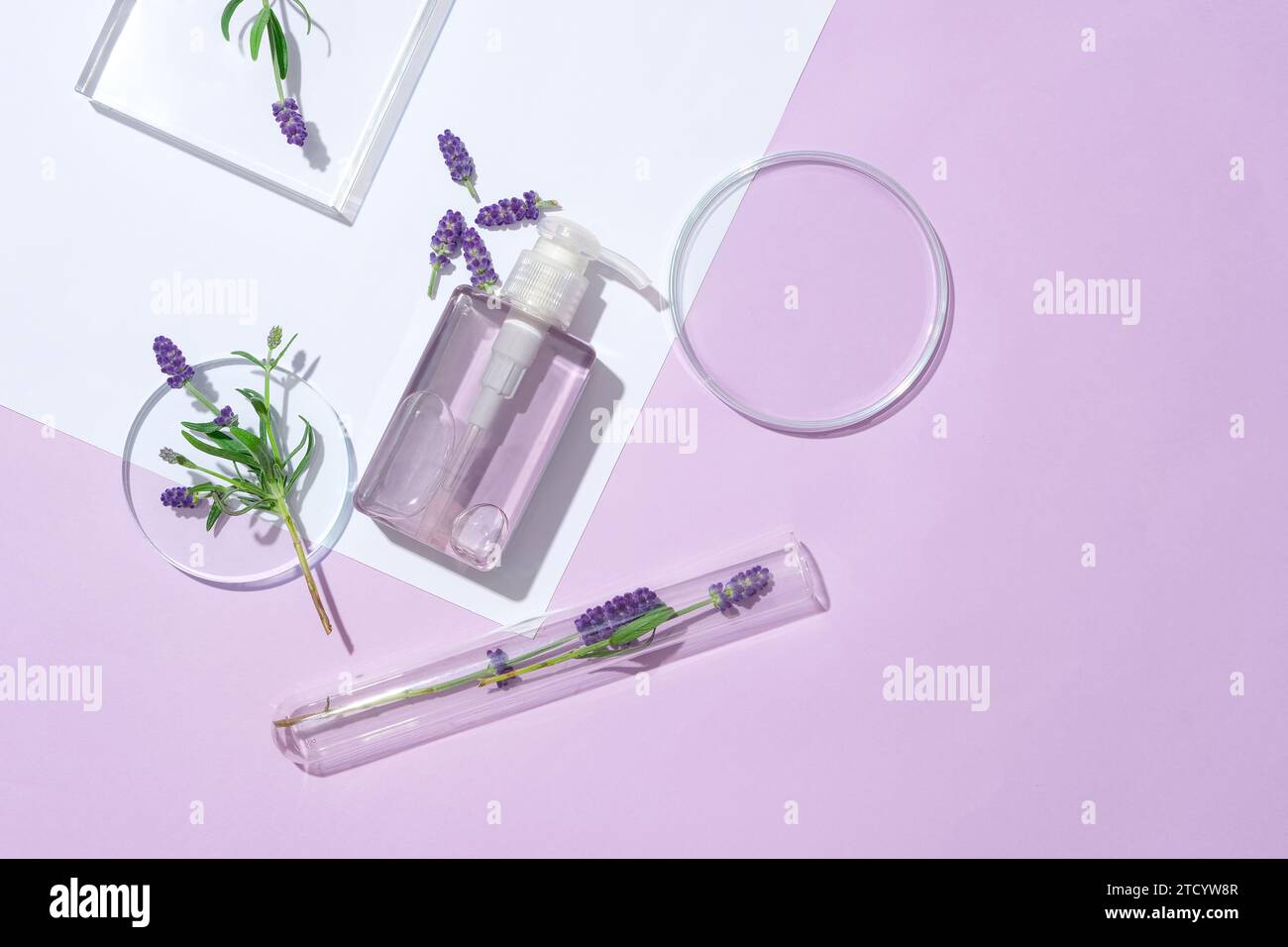 A transparent purple spray bottle without label, lavender flowers, a ...
