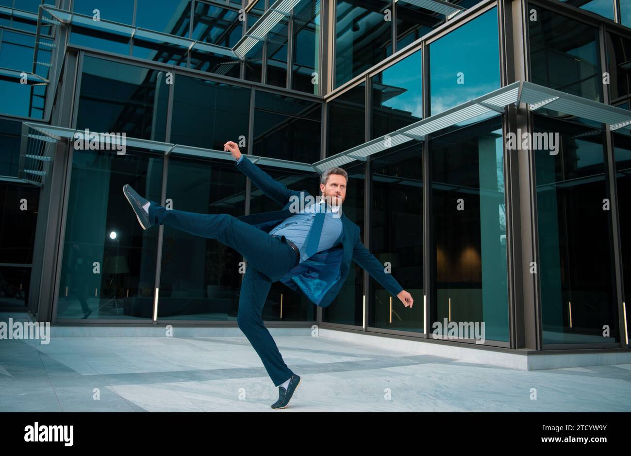Business excitement. Business man keeping arms raised and expressing ...