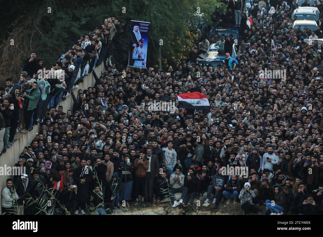 15 December 2023, Iraq, Baghdad: People watch military cadets of the ...