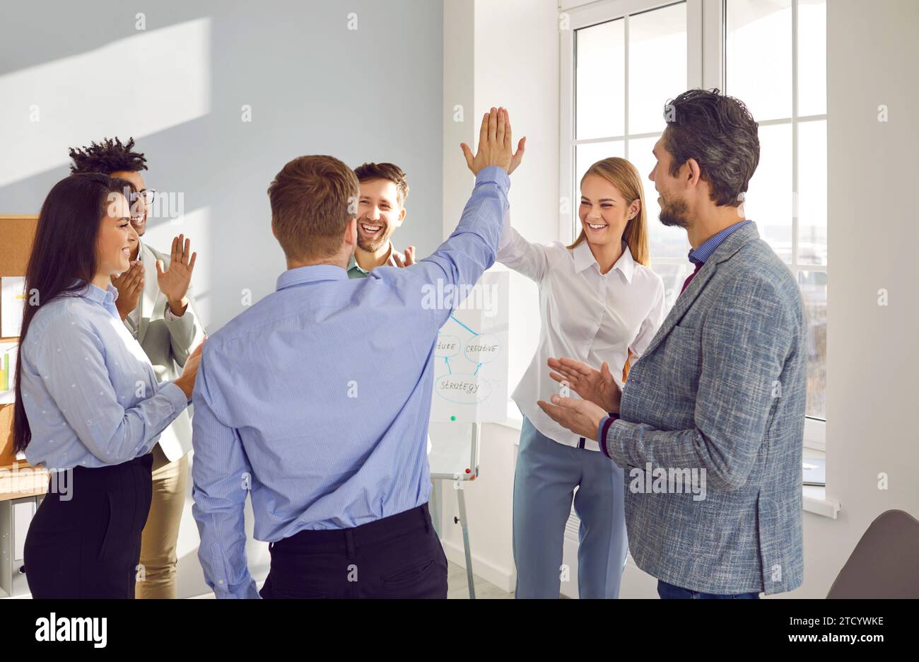 Business people giving high five and clapping at office meeting Stock ...