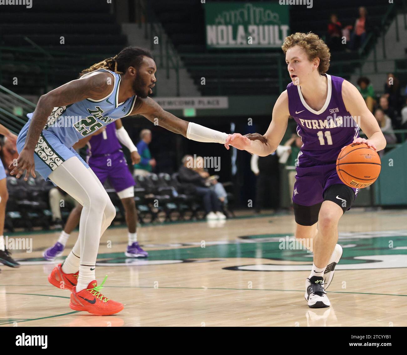 Furman Paladins guard Carter Whitt (11) tries to drive past Tulane ...