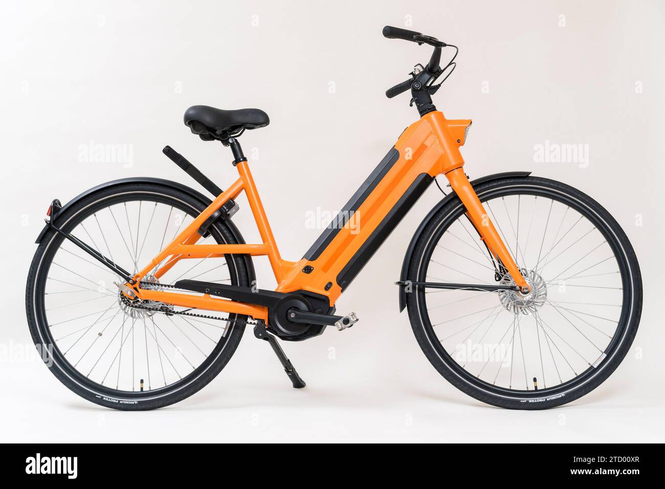 Photographs and details of a modern electric bike in orange against a ...