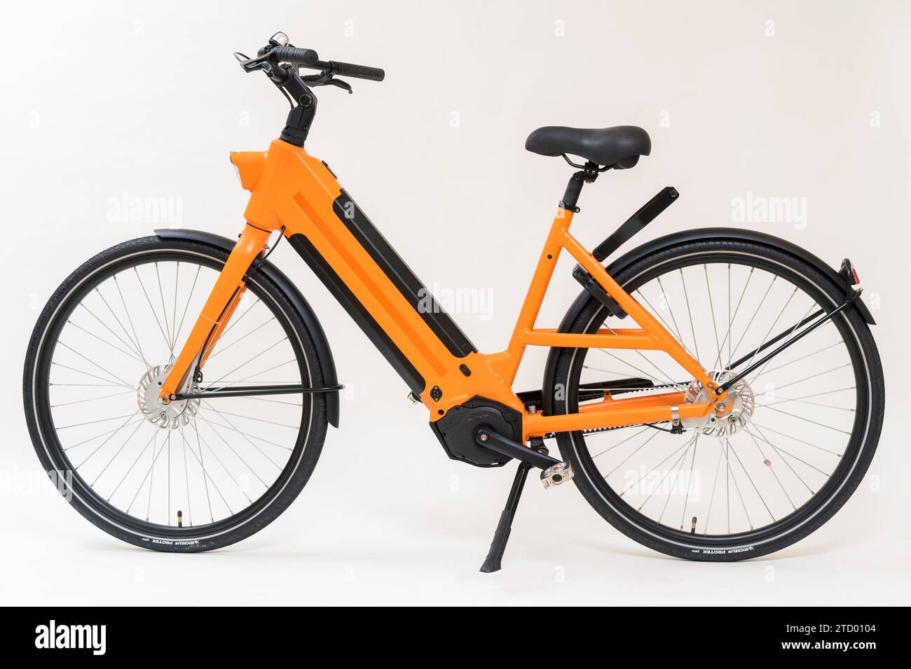 Photographs and details of a modern electric bike in orange against a ...