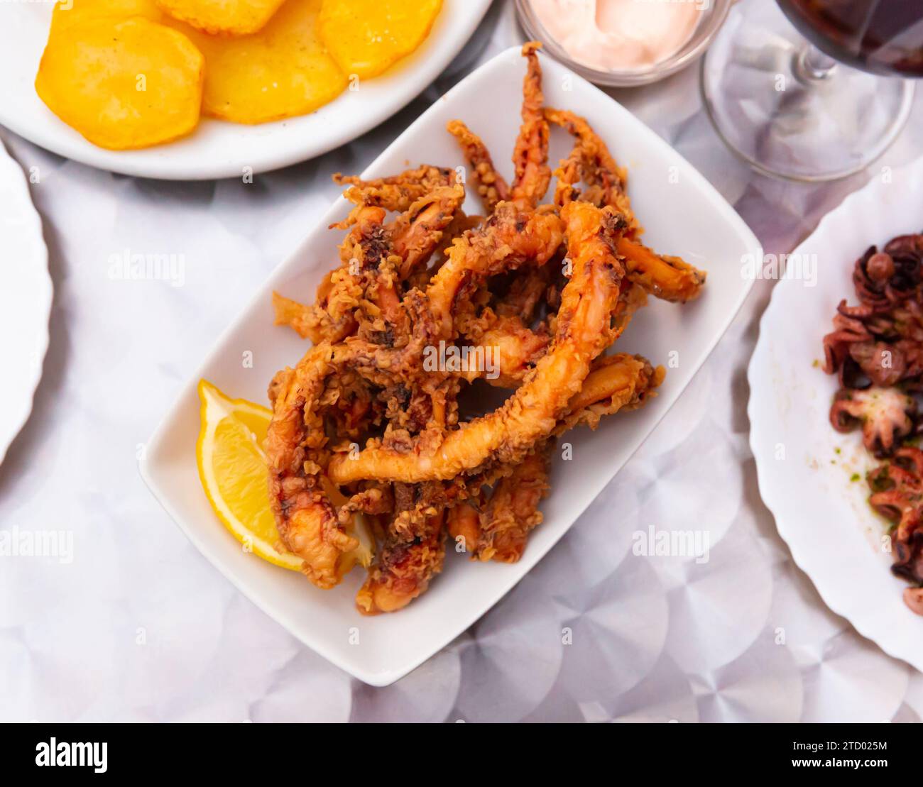 Spanish tapa rejos - fried spicy tentacles of squid served with lemon ...