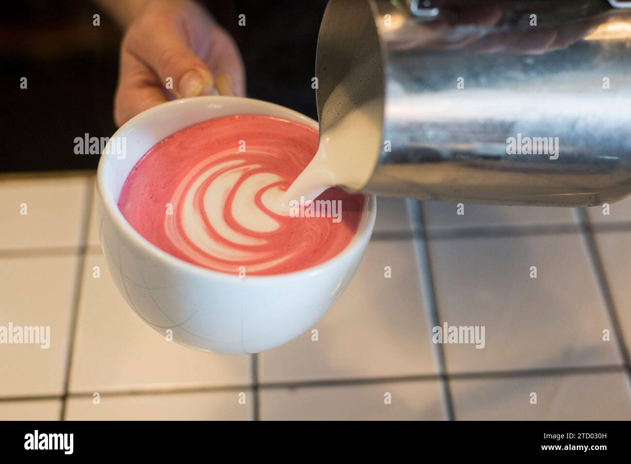 Photos of someone making a coffee. A beetroot latte in a coffee shop ...