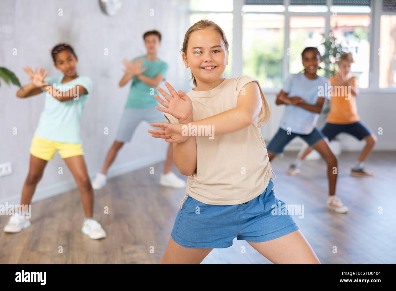 Energetic tween girl practicing vigorous movements in children dance ...