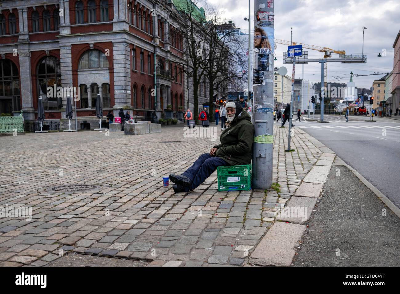 A homeless person is seen resting on one of the streets around the ...