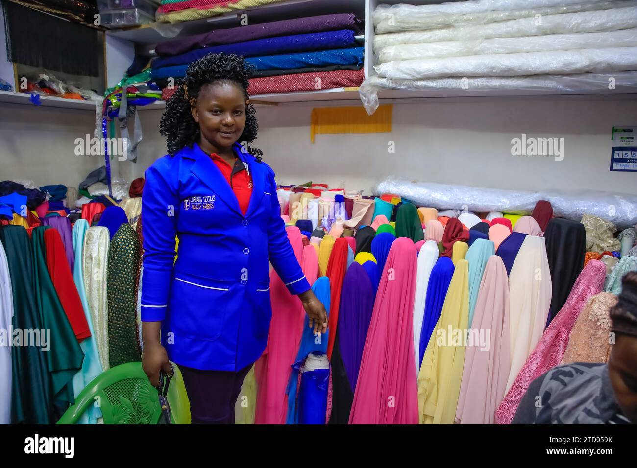 A trader is selling fabric products at a textile shop in Biashara ...