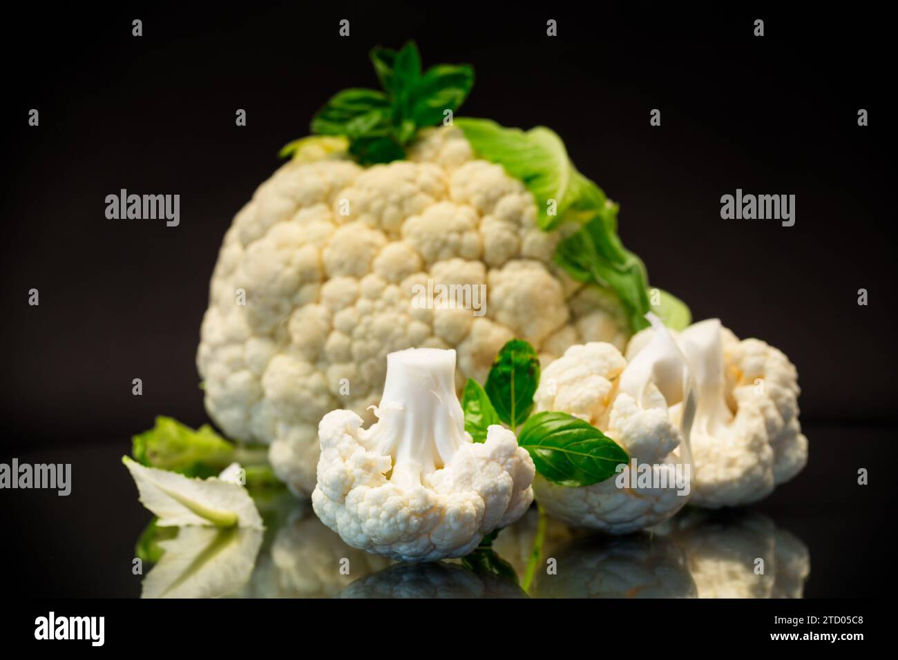 slices of raw small raw cauliflower isolated on black background Stock ...