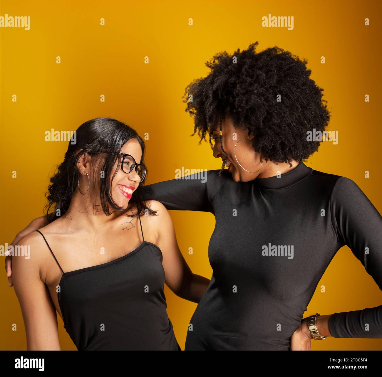 Two friends wearing black clothes, cheerful and happy, playing and ...