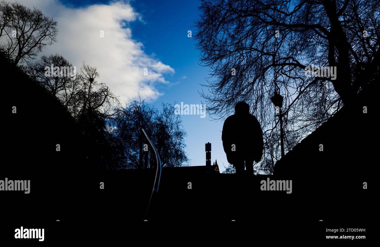 Silhouette at the entrance to Greyfriars Kirkyard in Candlemaker Row ...