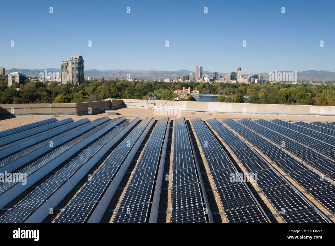 Solar panels on the roof of a museum with the city of Denver in the ...