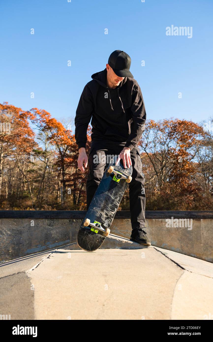 Solo Man skateboarding at the a skatepark in autumn Stock Photo - Alamy