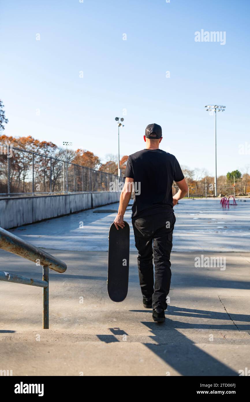 Solo Man walking through the skatepark in autumn Stock Photo - Alamy