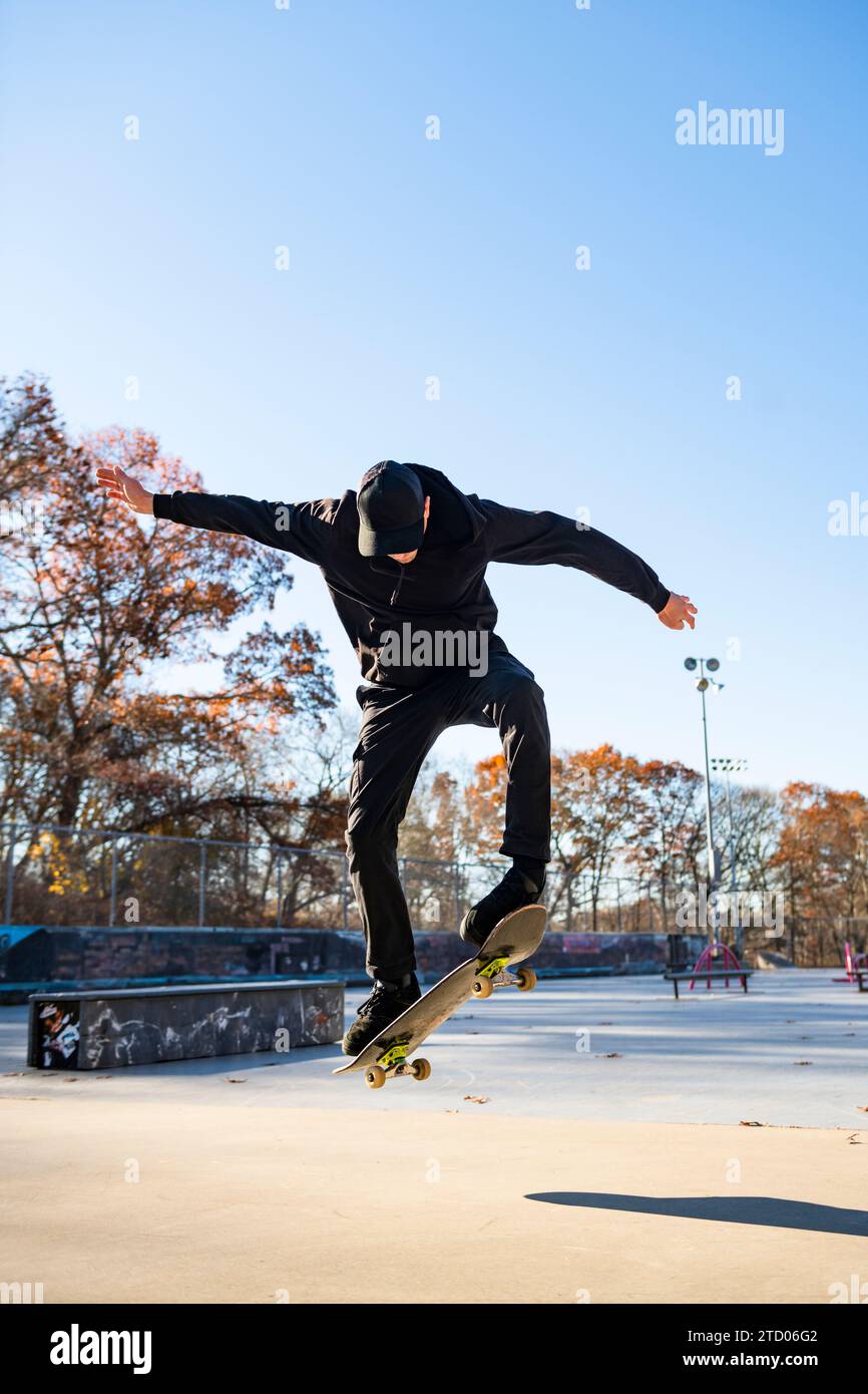Solo Man skateboarding at the a skatepark in autumn Stock Photo - Alamy