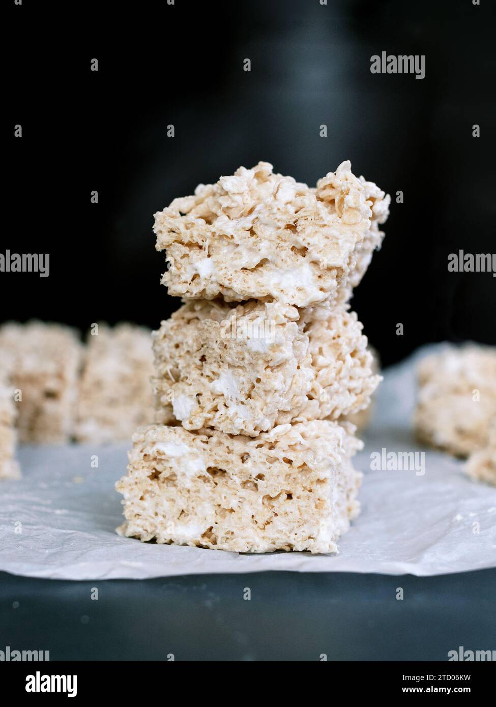 rice krispie treat on parchment and blue background Stock Photo - Alamy