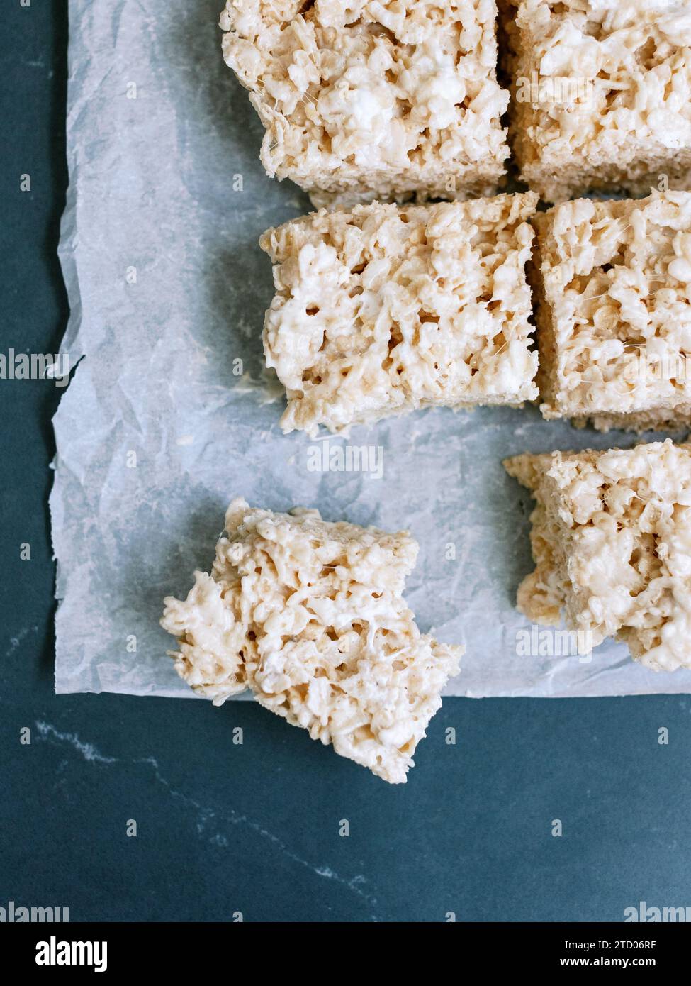 Rice Krispie Treats on parchment paper and blue marble background Stock ...