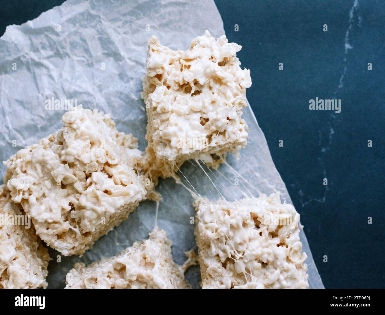 Rice Krispie Treats on parchment paper and blue marble background Stock ...