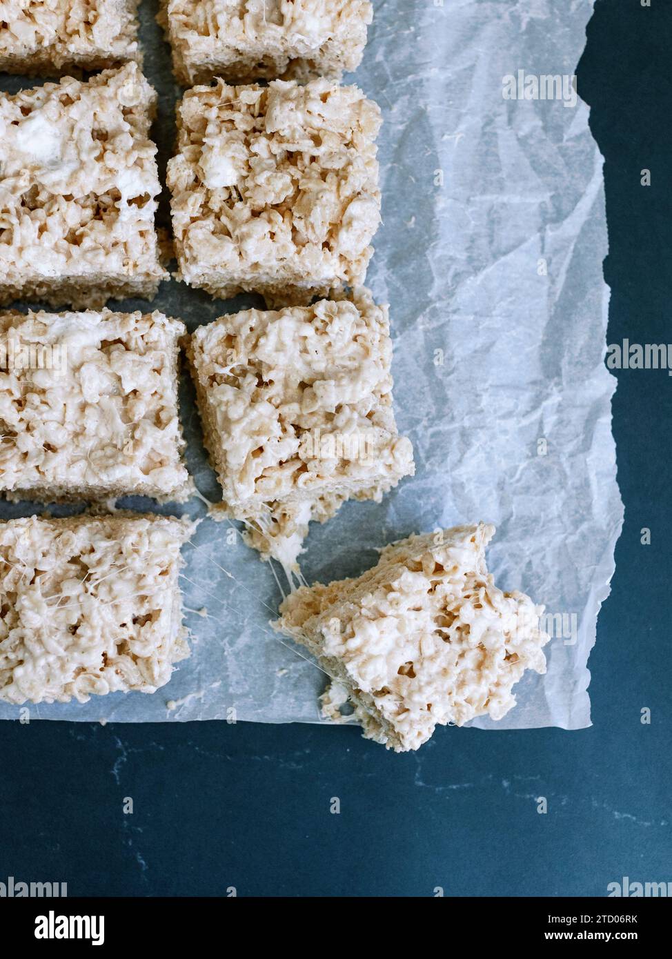 Rice Krispie Treats on parchment paper and blue marble background Stock ...