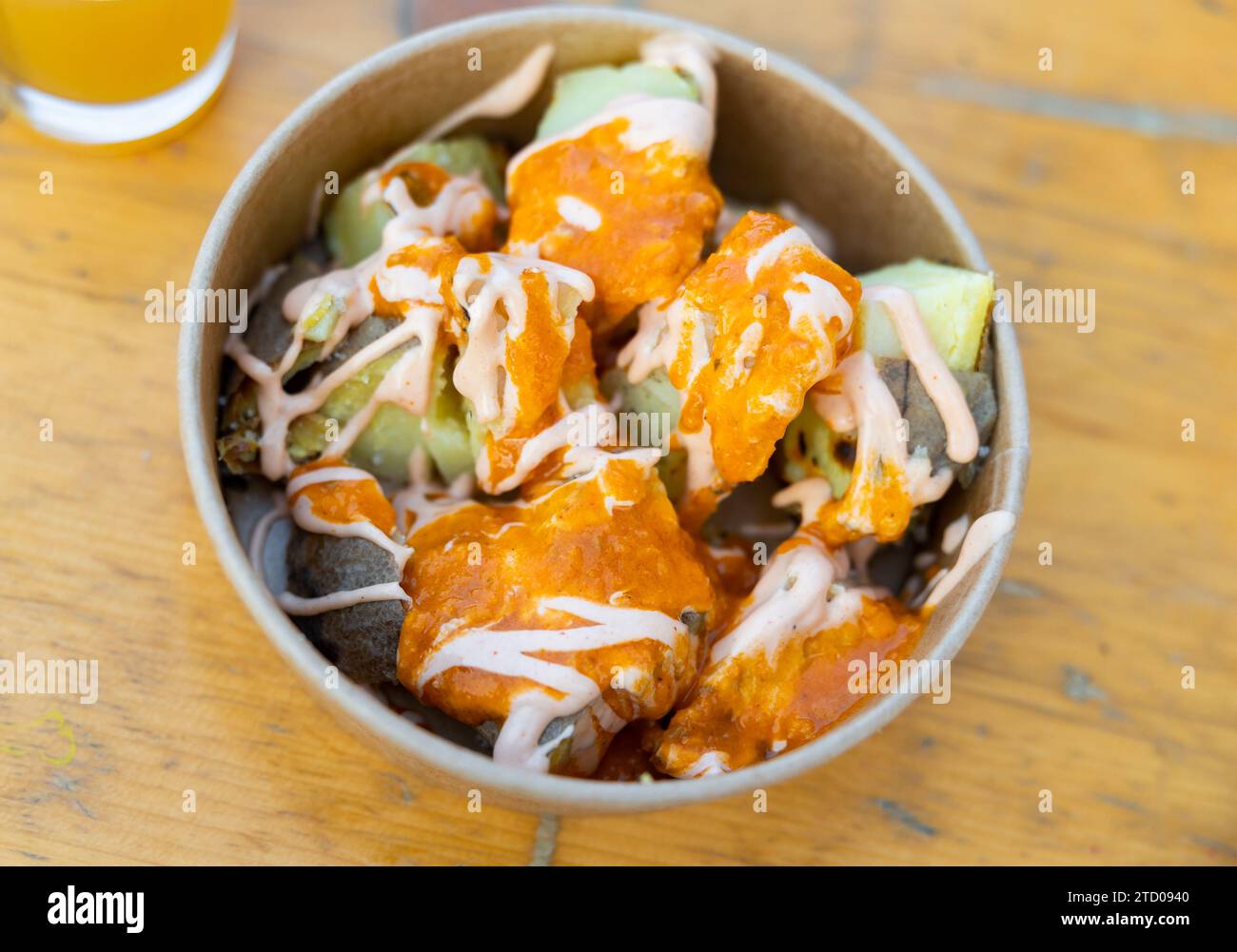 Spanish dish Patatas bravas, baked potato pieces with spicy sauces ...