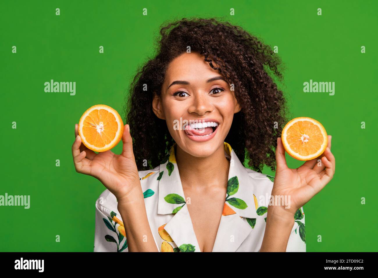 Photo of adorable flirty lady wear print shirt holding citrus halves ...