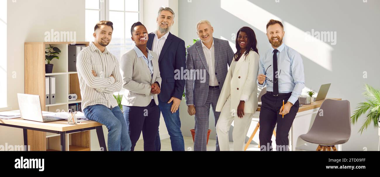 Portrait of successful multicultural business people posing together in ...