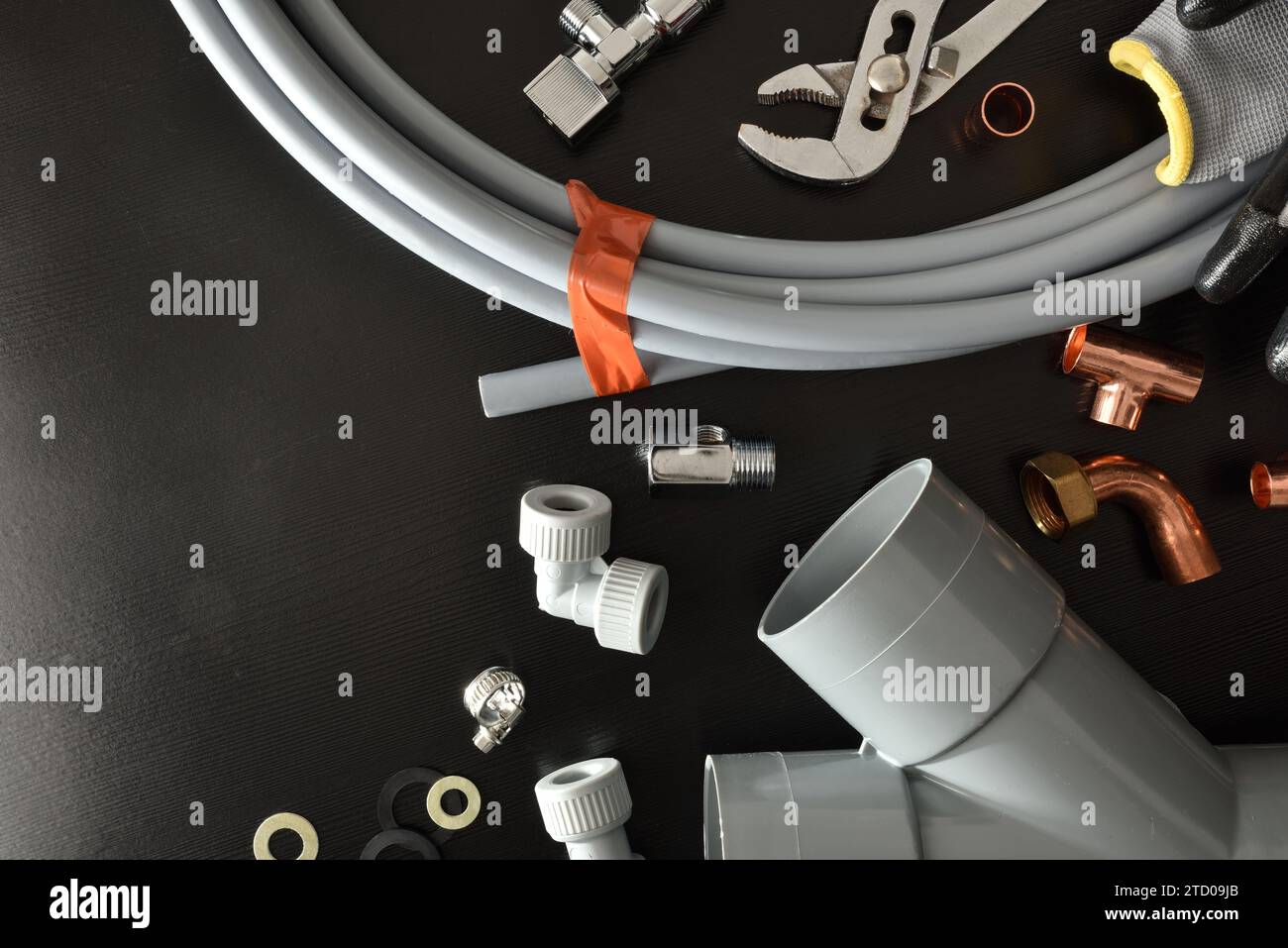 Group of plumbing materials and tools on black workbench. Top view ...
