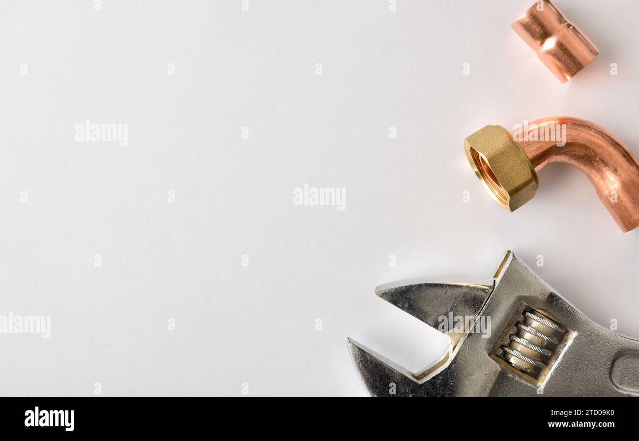 Plumbing conceptual background with tools and metal pipes on white ...
