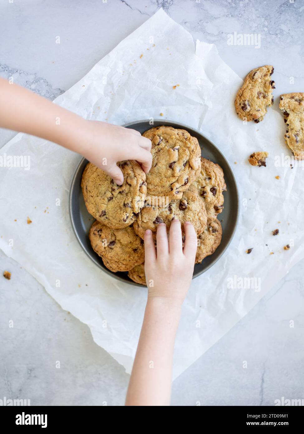 childrens hands reaching for homemade chocolate chip cookies on Stock ...