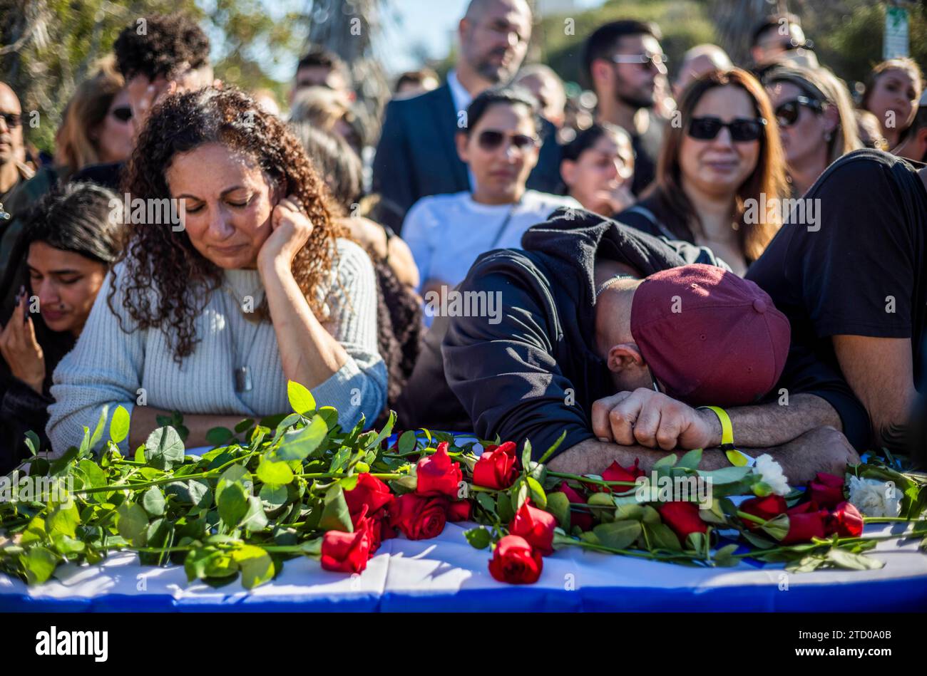 15 December 2023, Israel, Palmachim: Family and friends mourn during ...