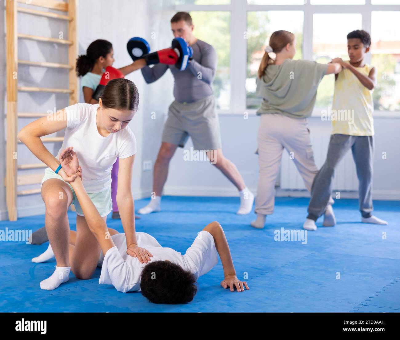 Boy and girl practicing self-defense techniques Stock Photo - Alamy