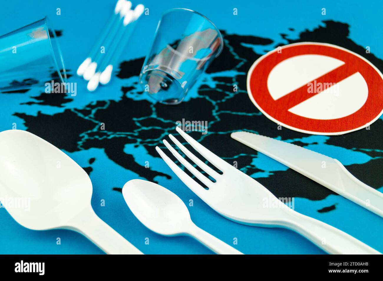 Plastic objects, cutlery, cups and cotton buds on European map with ...