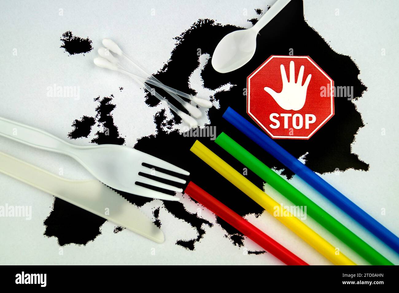 Straws, cutlery and cotton buds on a map of Europe with a stop sign ...