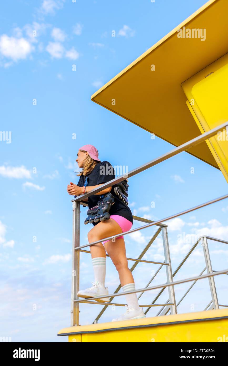 Low angle full body of young Caucasian woman dressed in casuals with ...
