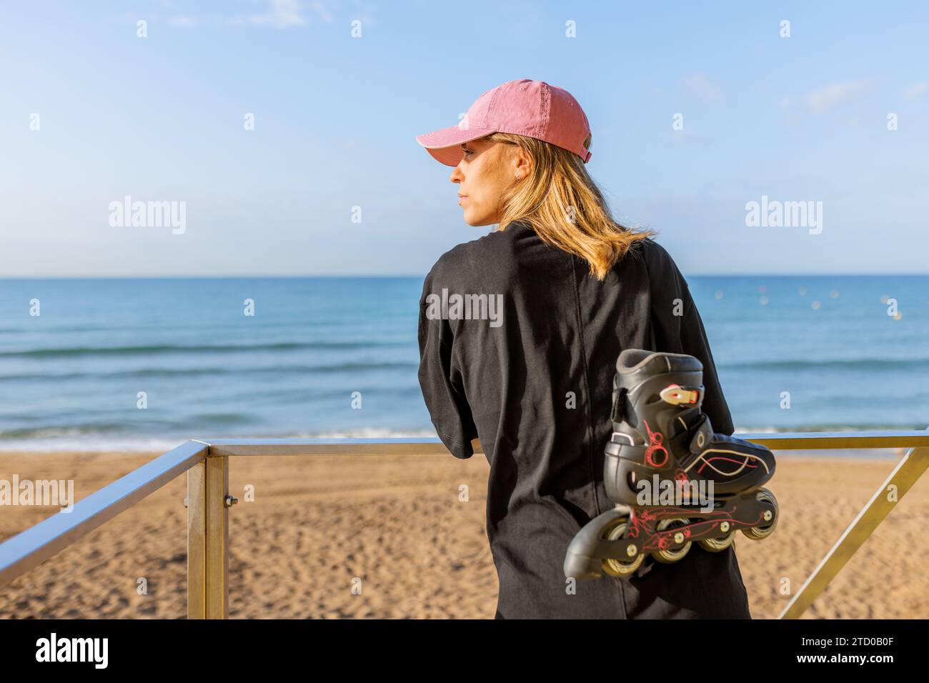 Back view of young Caucasian woman dressed in casuals with inline ...