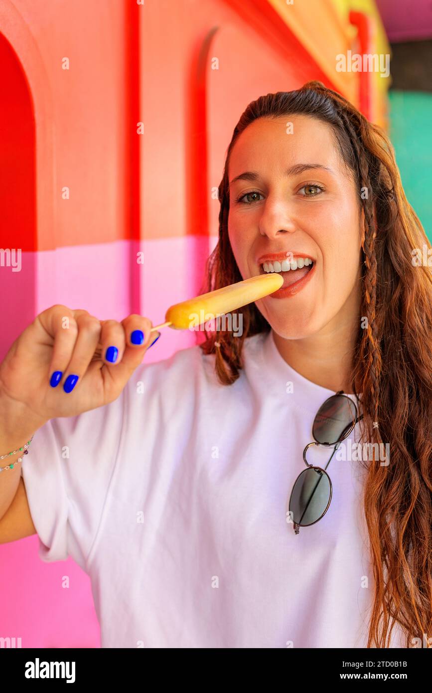 Portrait of beautiful Caucasian young brunette woman eating ice cream ...