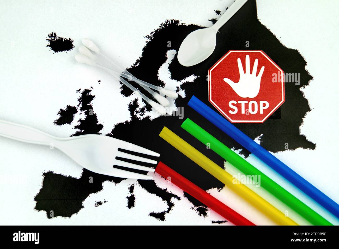 Straws, cutlery and cotton buds on a map of Europe with a stop sign ...