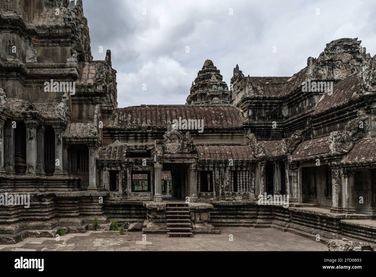 Moody overcast skies loom above the ancient temple ruins of the Angkor ...