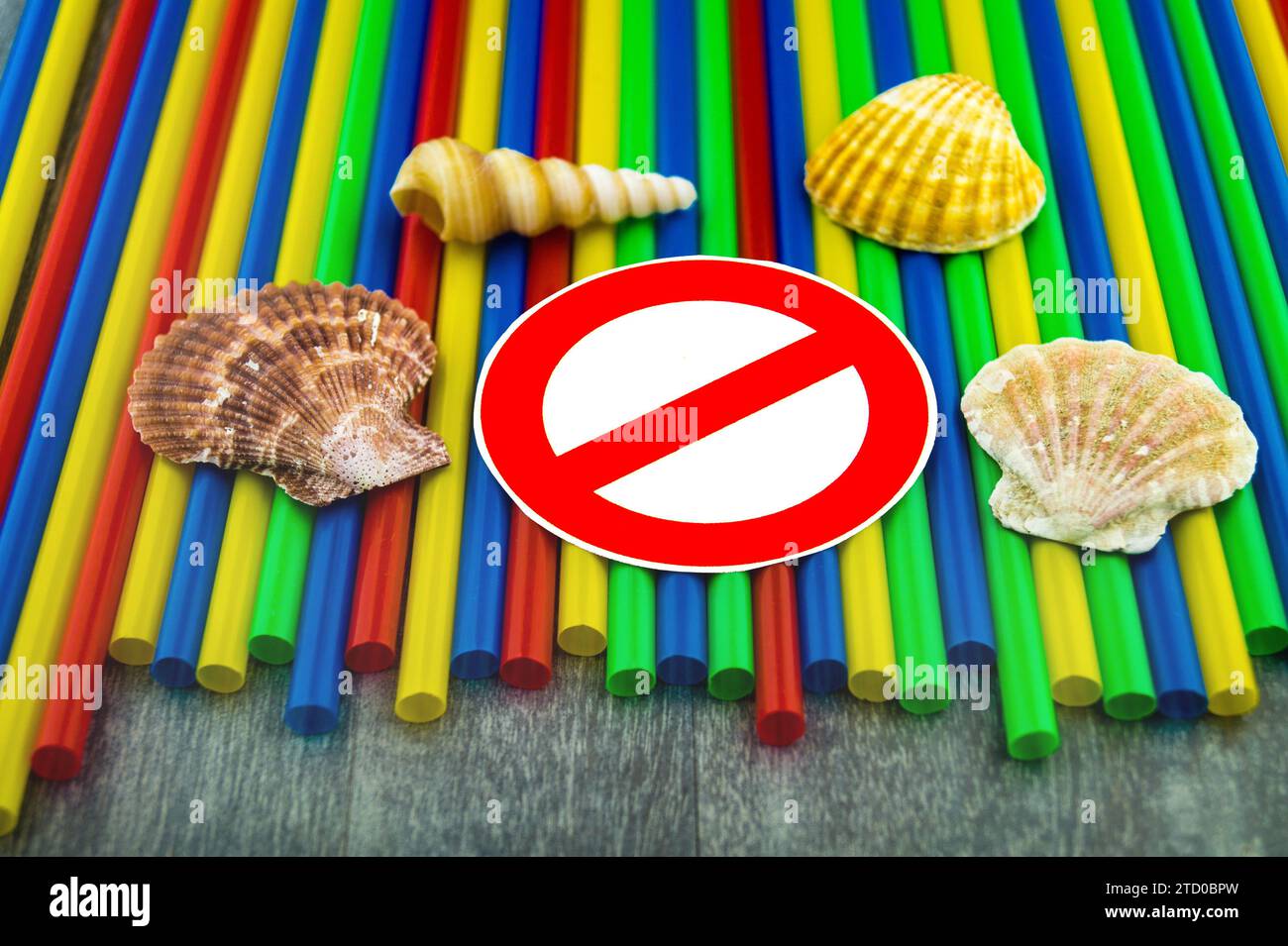 Plastic straws with prohibition sign, shells and snail shells from the ...