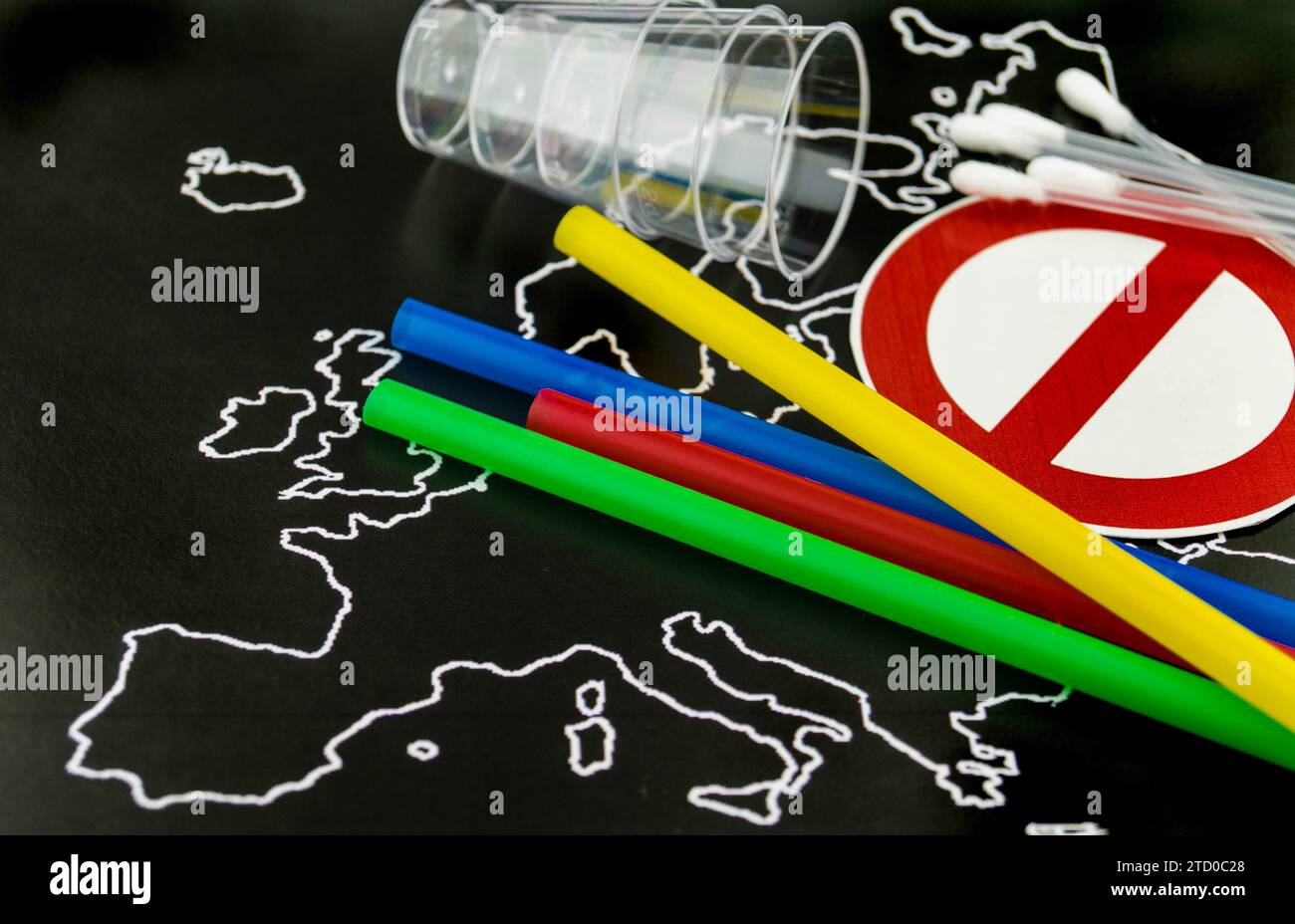Plastic straws, cups and cotton buds on a map of Europe with a ...