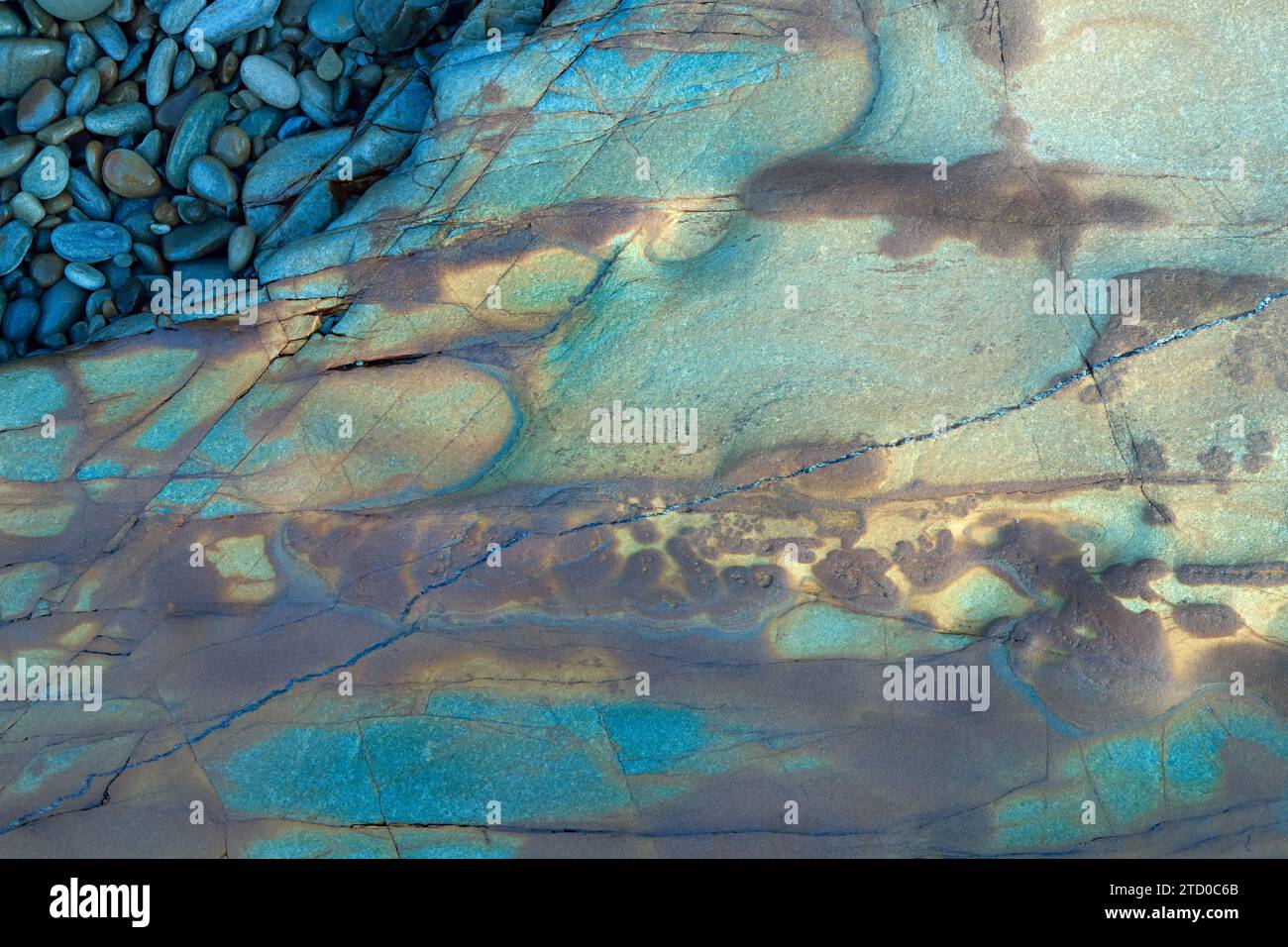 An abstract pattern of colorful rocks and pebbles with natural textures ...