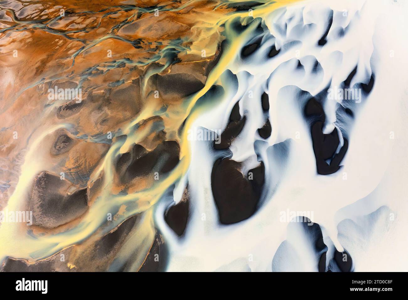 Aerial shot of a river basin in Iceland, displaying an intricate blend ...