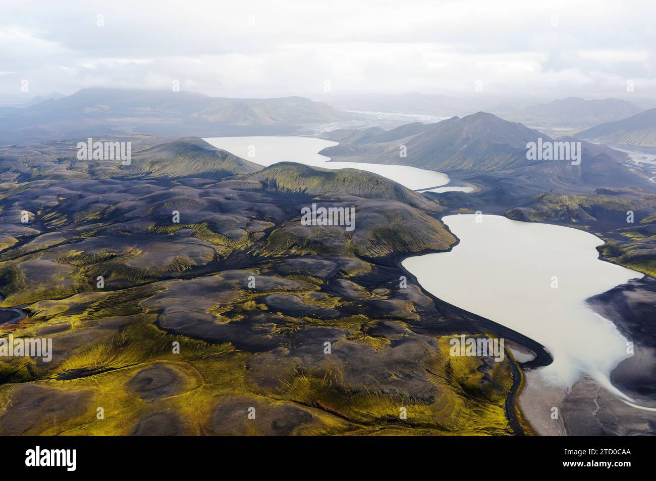 Aerial view of Iceland's rugged landscapes featuring winding river ...