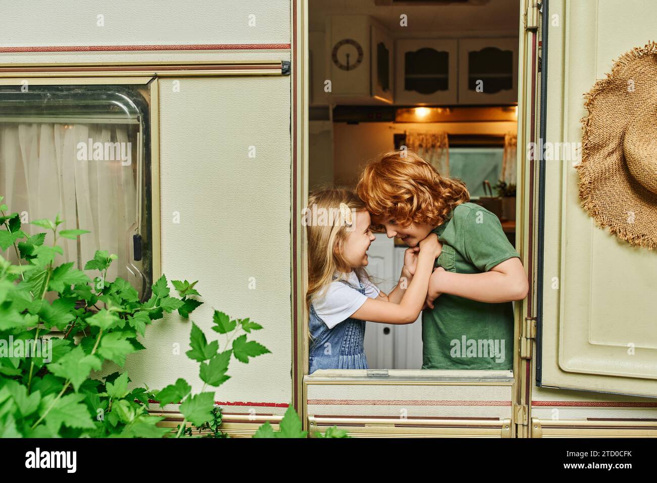 joyful brother and sister having fun inside trailer home, happiness and ...