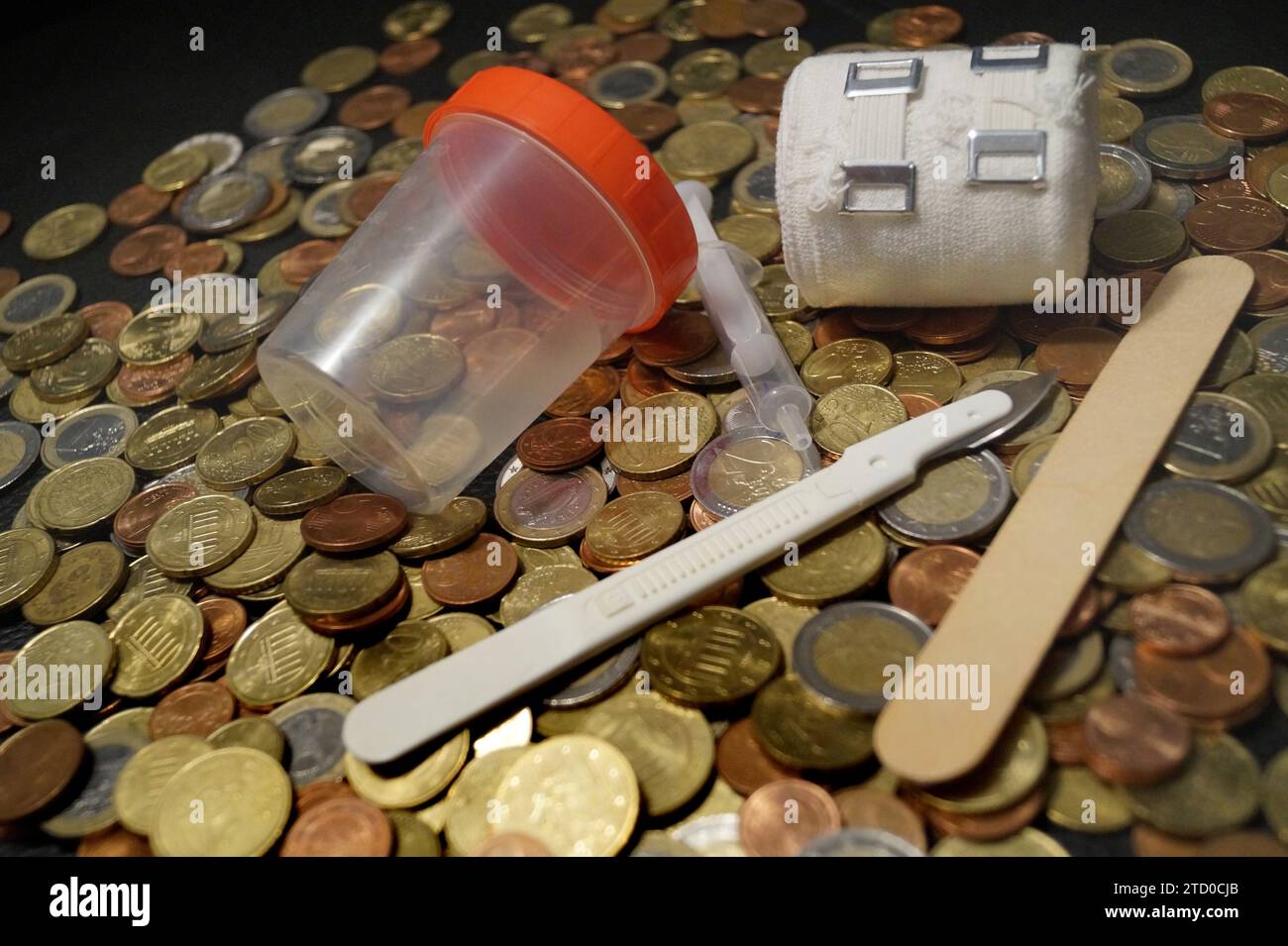 Cup, bandage, scalpel, syringe, wooden spatula with Euros, symbolic ...